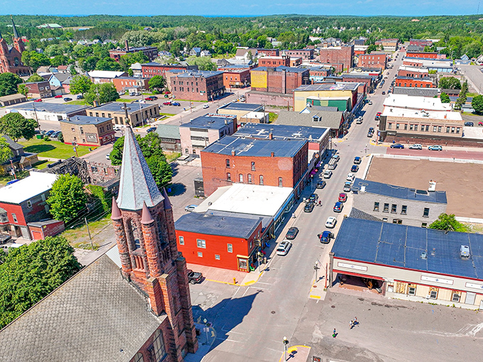 Calumet unfolds from above like a historical diorama, where church spires still watch over streets once walked by copper kings.