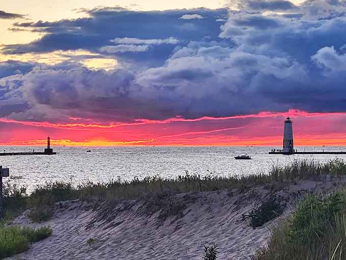 Elberta's lighthouse stands dramatically against a painted sky, nature's own masterpiece framing this iconic Michigan landmark.