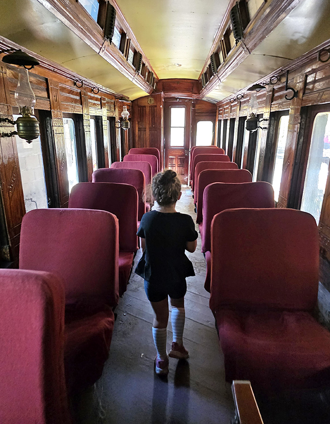 A young explorer navigates the historic coach, discovering the simple joy of train travel that has captivated children's imaginations for generations.