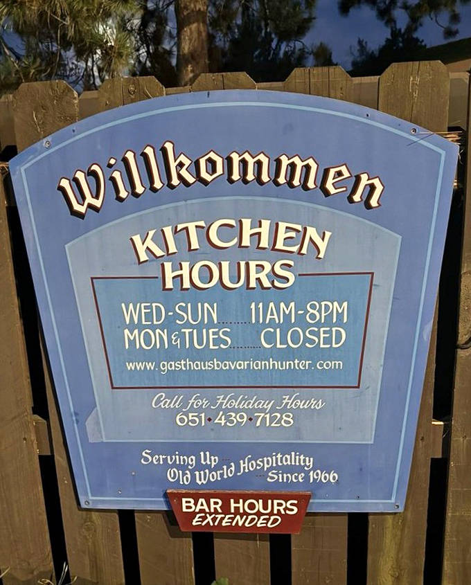 The sign announces kitchen hours with "Willkommen" warmth &ndash; a friendly reminder that German punctuality applies even to your schnitzel cravings.