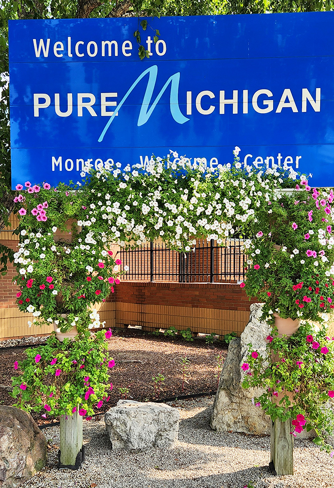 This floral archway frames Michigan's welcome sign in a burst of pink and white blooms, creating the perfect Instagram moment for summer visitors.