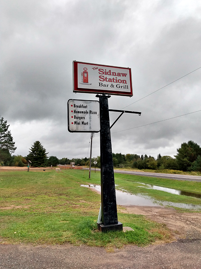 The iconic Sidnaw Station sign stands as a beacon for hungry travelers, promising fuel for both vehicles and appetites.