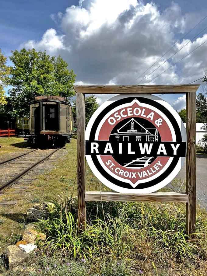 The Osceola & St. Croix Valley Railway sign stands as a proud invitation to experience Wisconsin's natural beauty from the unique vantage point of historic rails.