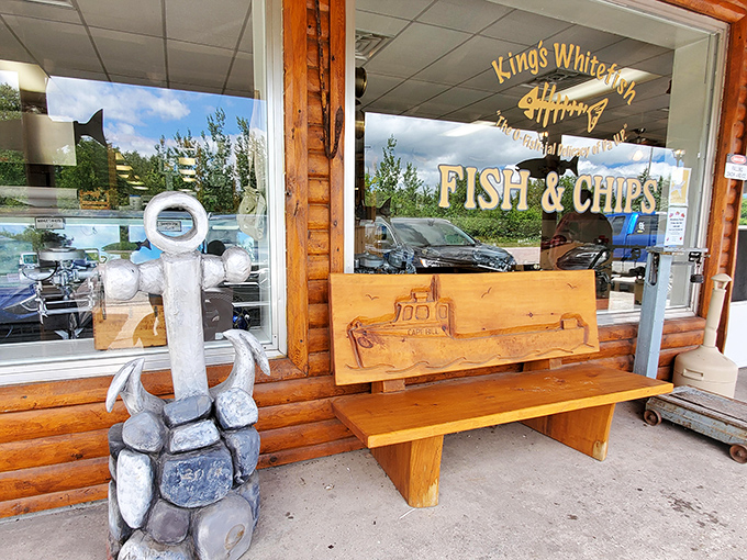 Hand-carved with a fishing boat motif, this wooden bench invites visitors to pause and breathe in the smoky, savory promise of what's inside.