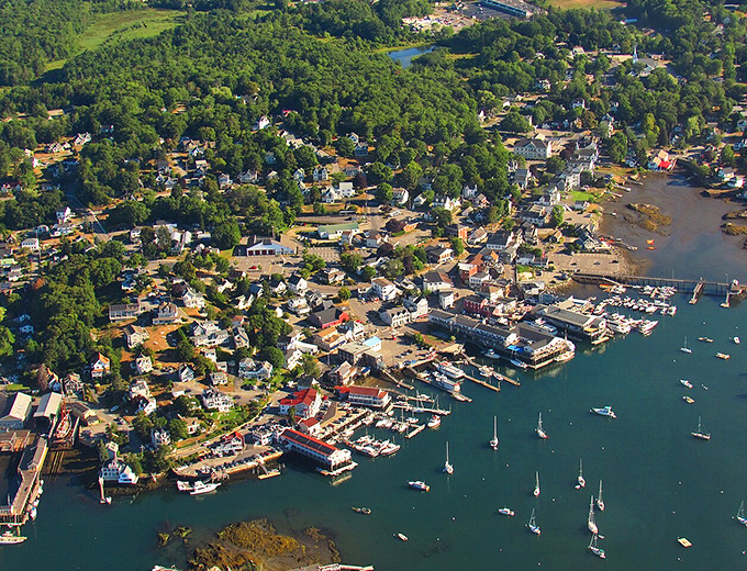 An aerial perspective reveals Boothbay's perfect natural harbor, where land embraces water in a geographical hug centuries in the making.
