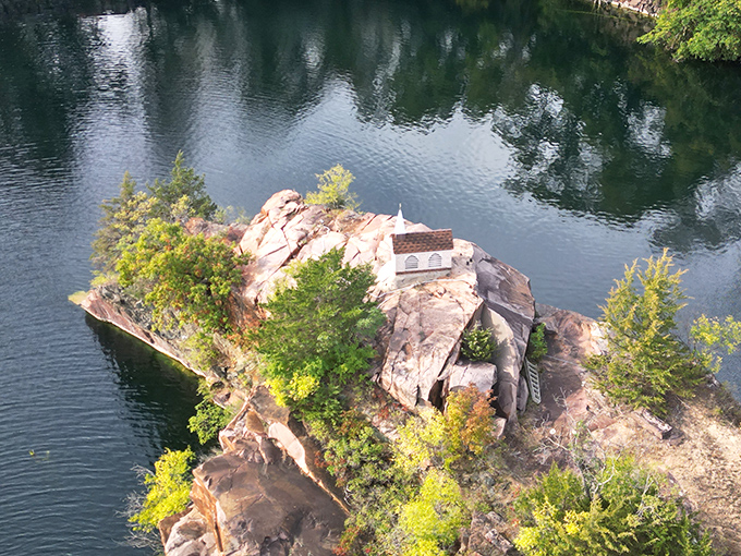 A bird's-eye view reveals the tiny chapel perched dramatically on its granite island, looking like the perfect setting for a fairy tale ending.