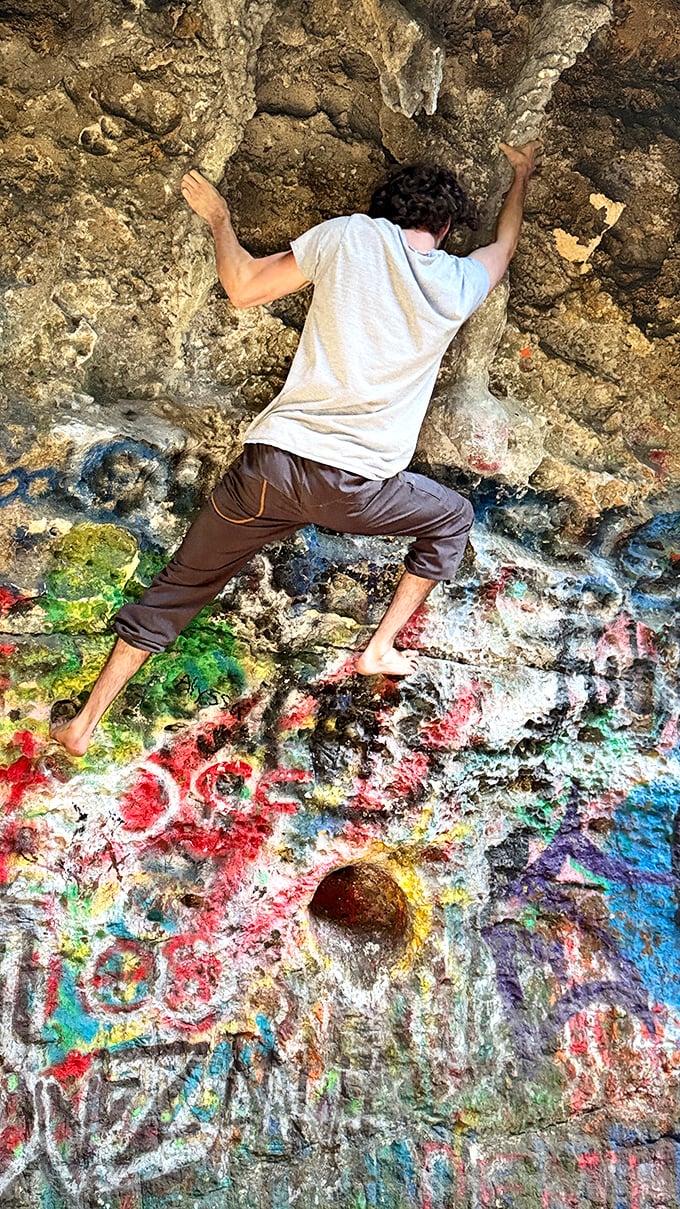 Barefoot bouldering at its finest! This adventurous climber tests his skills on the surprisingly grippy surface of Florida's painted cave walls.
