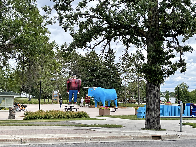 A distant view reveals how Paul and Babe command attention in the landscape, standing sentinel over their lakeside domain.