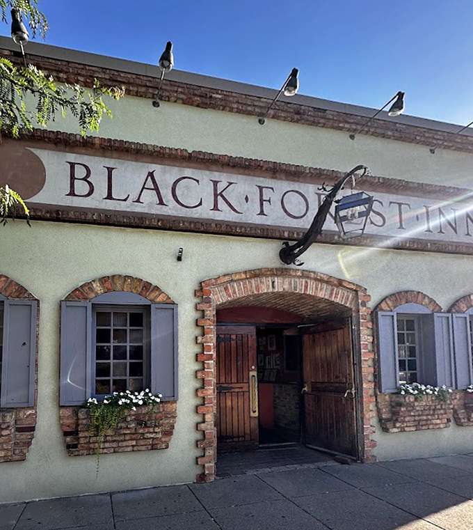 The welcoming entrance promises authentic German experiences beyond its wooden doors. This isn't just a restaurant sign, it's a portal to deliciousness!