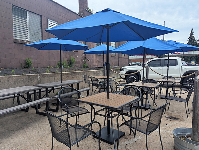 The outdoor patio at Mac's offers al fresco dining under bright blue umbrellas &ndash; Minnesota summer perfection with fried fish in hand.
