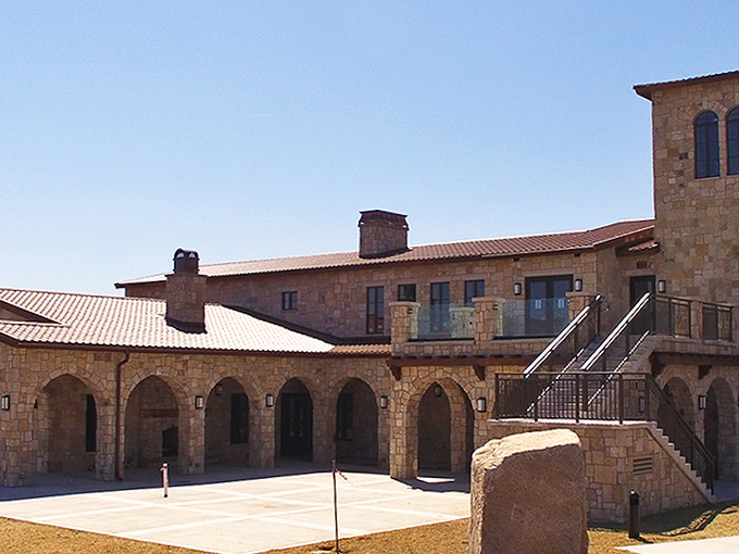 Arched walkways and meticulous stonework create an atmosphere of timeless elegance, proving that world-class wine experiences can be found in unexpected corners of Michigan.
