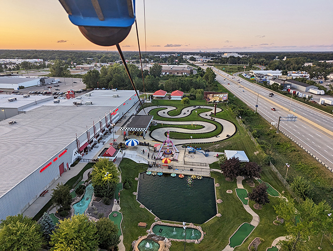 Overview from cable car: The entire kingdom of family entertainment spread out below, a colorful patchwork of attractions designed to create memories that outlast the day itself.