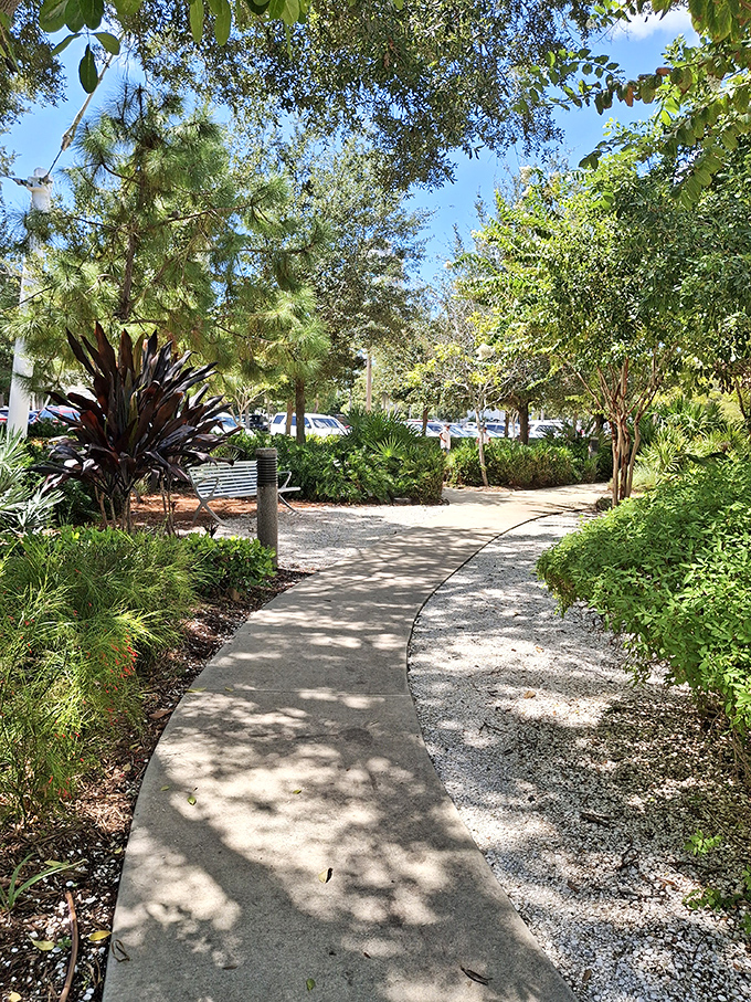 Shaded pathways wind through native Florida plantings, offering peaceful moments between playground adventures and waterfront explorations.