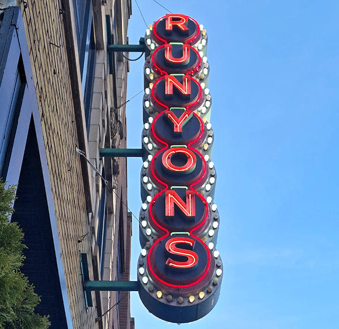 The vertical "RUNYON'S" sign glows like a beacon for wing lovers, a neon North Star guiding hungry pilgrims home.