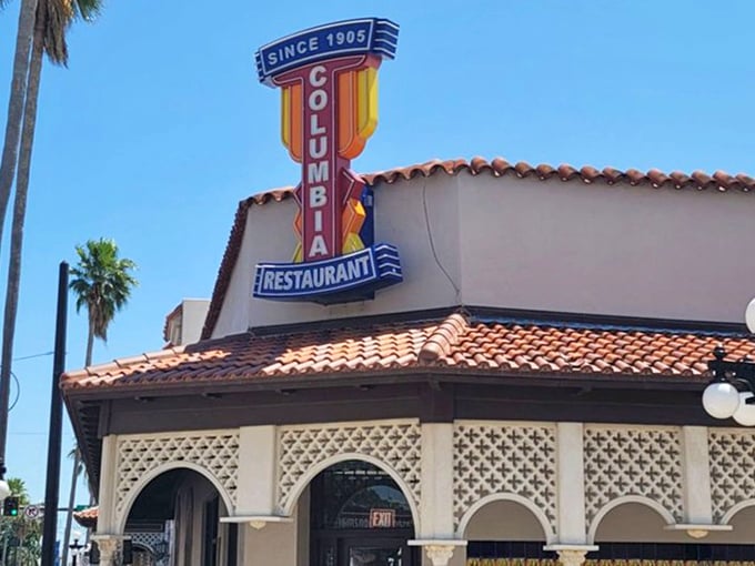 The iconic neon sign has guided hungry visitors to this culinary landmark since 1905, a beacon of authentic Spanish-Cuban cuisine.