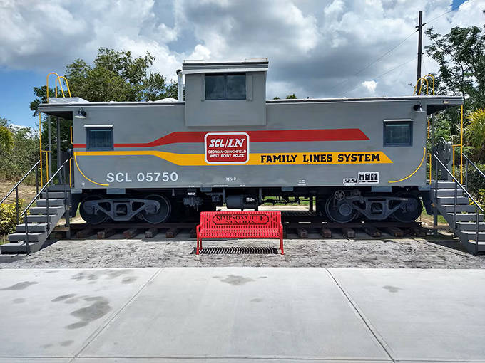 Take a seat on the bright red Simpsonville Station bench and admire the full exterior of this historic silver caboose.