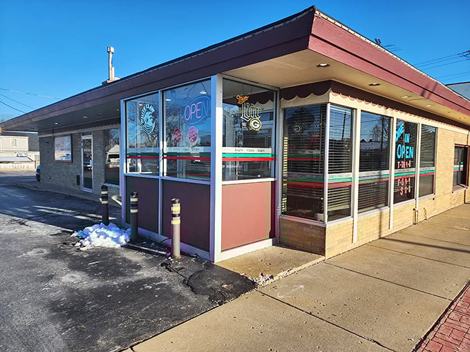 Luigi's Pizza Kitchen's welcoming storefront invites pizza lovers with its classic red and green trim and bright "OPEN" sign beckoning hungry visitors inside.