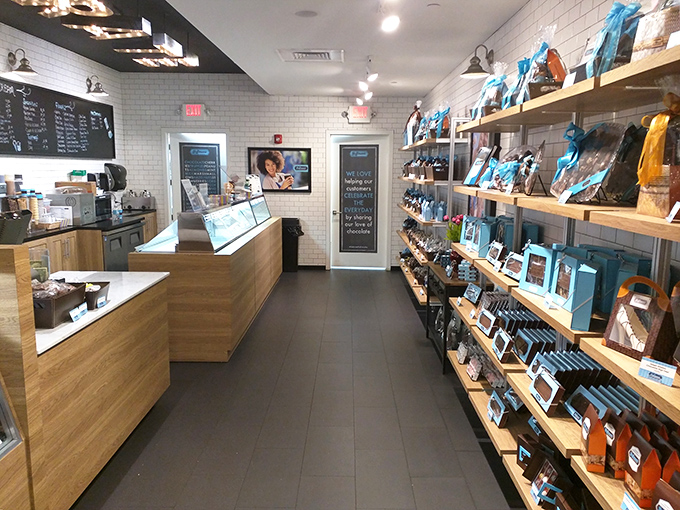 The sleek counter at Hoffman's welcomes chocolate lovers with rows of handcrafted delights, while subway tile walls add a touch of modern charm.