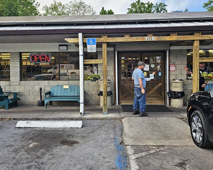 A simple wooden entrance marks the spot where BBQ dreams come true. The "OPEN" sign is your invitation to smoky paradise.