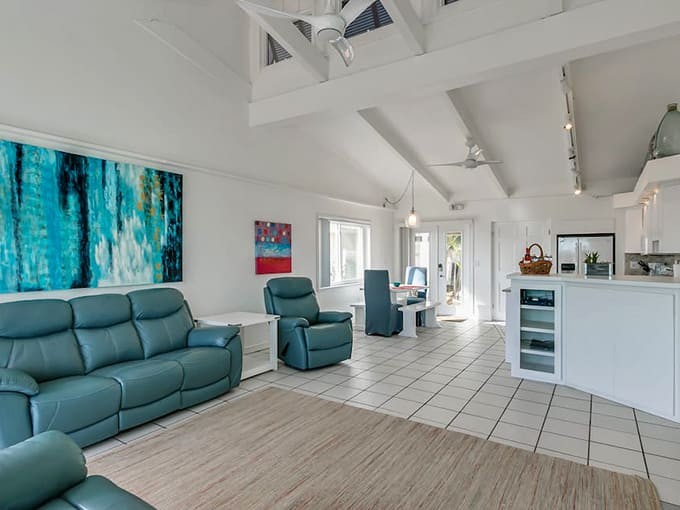 Vaulted ceilings and ocean-inspired decor create a living space where relaxation isn't optional, it's mandatory and wonderful.
