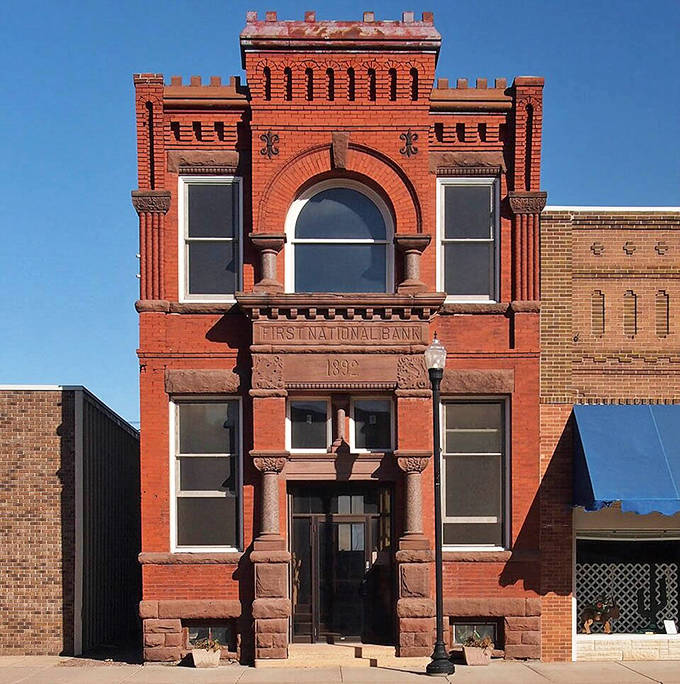 The historic First National Bank building from 1890 anchors downtown Dawson with its impressive brick architecture and ornate details that speak to the town's prosperous past.