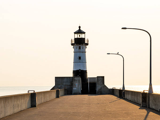 Standing sentinel at the harbor entrance, this black-and-white lighthouse has guided ships safely home through Superior's notorious storms for generations.