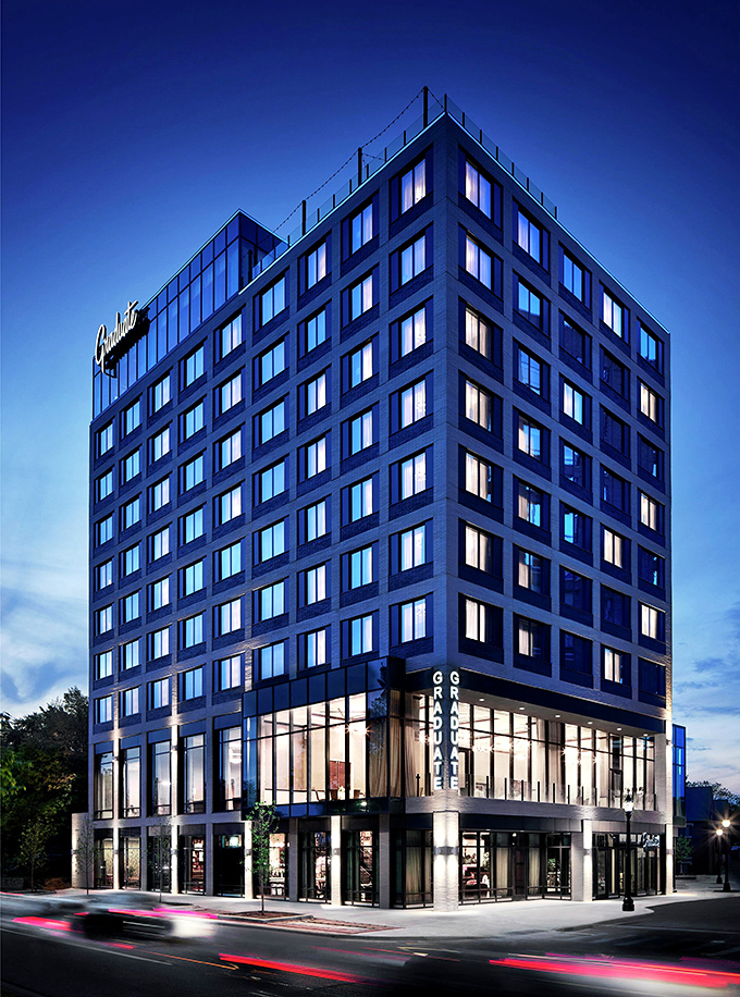 The Graduate East Lansing stands proudly against the Michigan sky, its modern architecture hinting at the unique experience within.