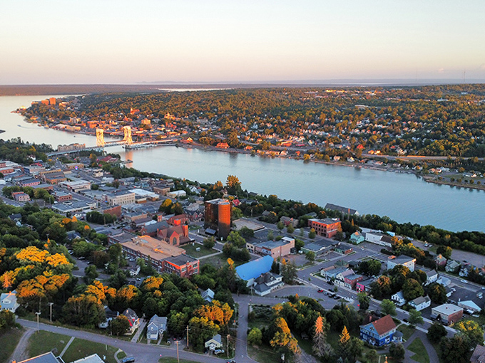 Sunset paints Harbor City in golden hues, where the waters of Portage Lake mirror the town's unique blend of Midwestern charm and Scandinavian influence.