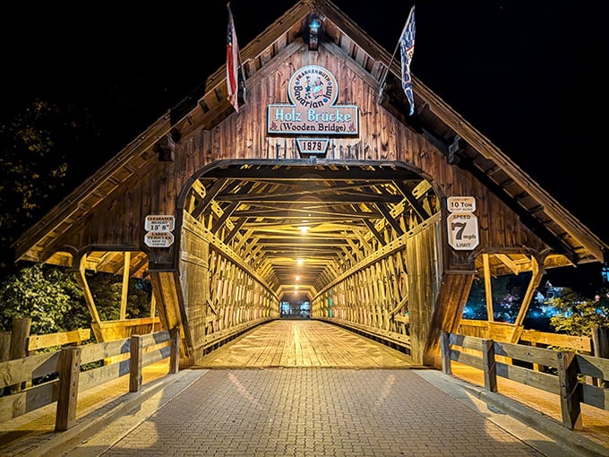 As night falls, the bridge transforms into a glowing passage of golden light, creating a magical tunnel that seems to transport crossers to another time.