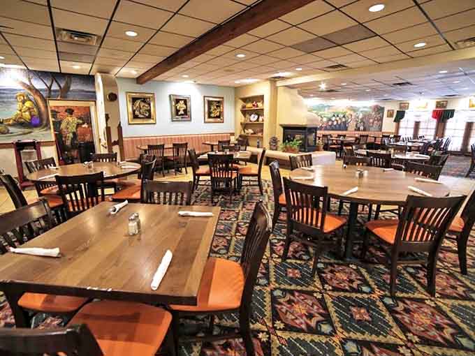 Wooden tables and colorful décor create a warm, inviting atmosphere where conversations flow as freely as the salsa in this spacious dining room.