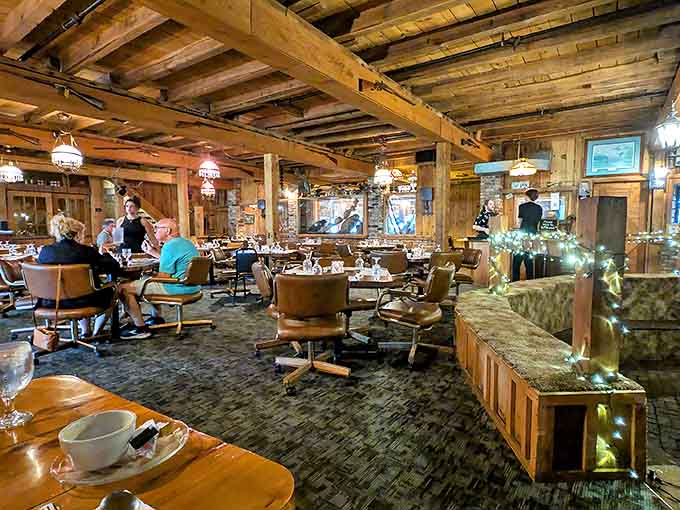 Massive timber beams frame an atmosphere where conversations flow as freely as the drinks, creating a dining room that feels both grand and intimate.