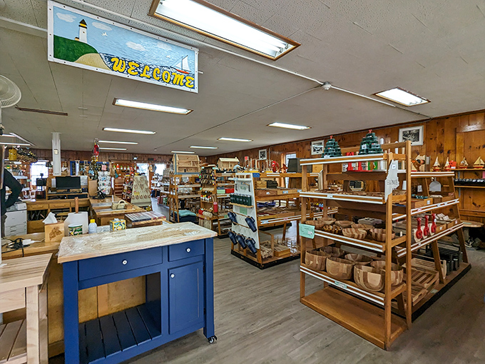 Warm wood paneling creates the perfect backdrop for displaying handcrafted items, with colorful buoys adding a playful Maine touch.