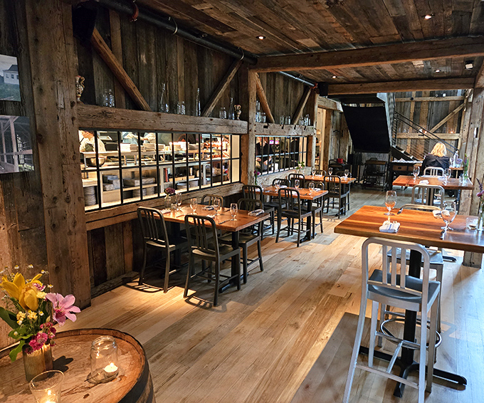 Inside, history meets hospitality with soaring wooden beams and warm lighting that transforms a 300-year-old barn into Michigan's most atmospheric dining room.