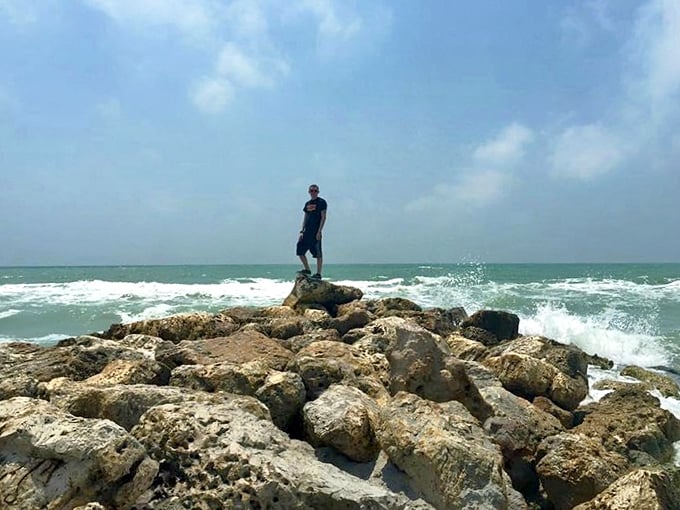 Standing on the rocky jetty feels like being at the edge of two worlds, with waves crashing dramatically below.