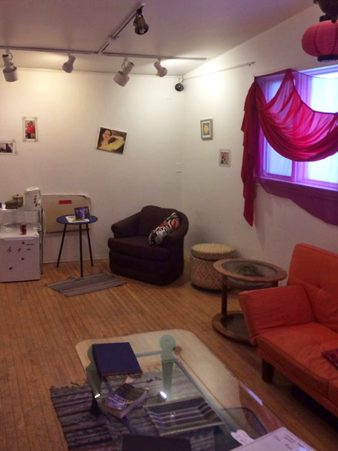 Cozy seating and red drapes create an inviting space reminiscent of a certain magical common room where wizards might relax between classes.