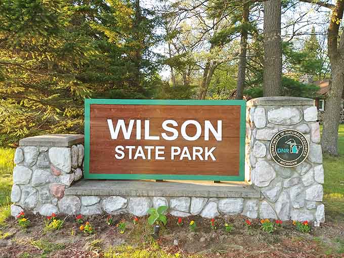 The welcoming stone sign stands sentinel, like a friendly neighbor saying "Come on in, the nature's fine!"