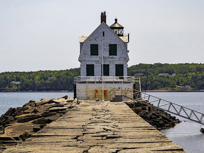 The classic New England architecture of Rockland Breakwater Lighthouse combines functionality with coastal elegance against Maine's azure waters.