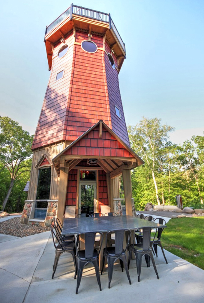 The front view showcases rustic elegance with its stone foundation and cedar shingles &ndash; nautical charm meets woodland retreat.