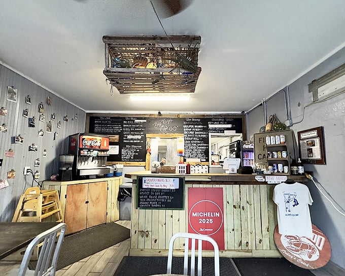 The heart of the operation – a compact counter where seafood dreams come true, complete with a lobster trap light fixture.