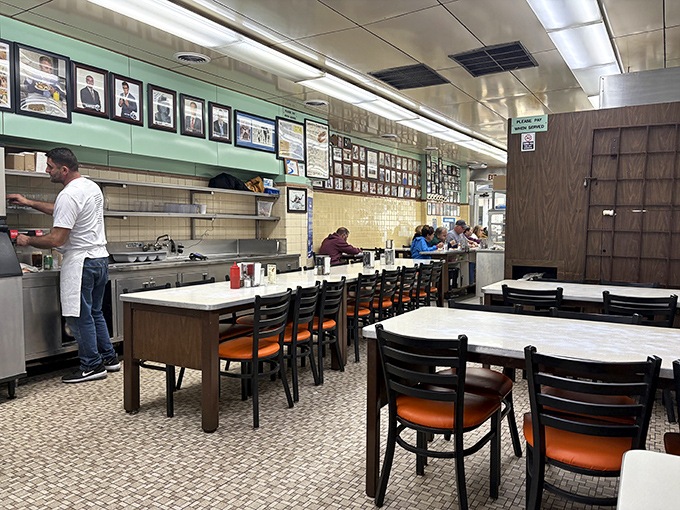Classic diner vibes with mint green trim and white tile walls create the perfect backdrop for serious hot dog consumption.