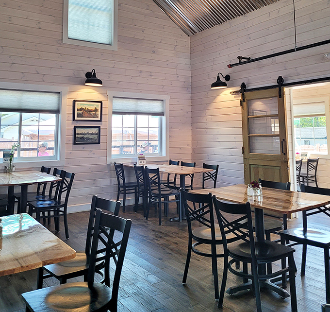 Soaring ceilings and light wood paneling create an atmosphere both airy and intimate, where every table feels like the best seat in the house.