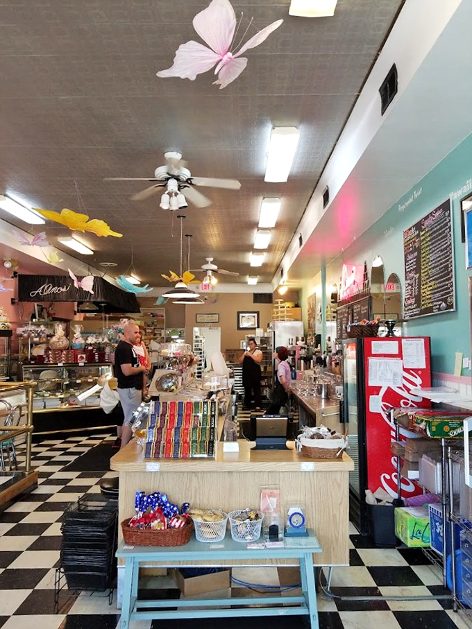 Colorful butterflies dance across the ceiling while the black-and-white checkered floor creates a nostalgic backdrop for sweet adventures.