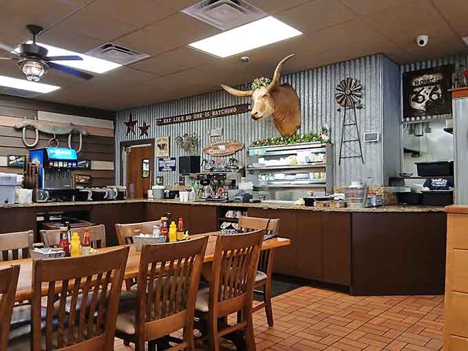 The rustic interior with corrugated metal, longhorn mounts, and wooden tables creates an atmosphere that's pure country charm without trying too hard.