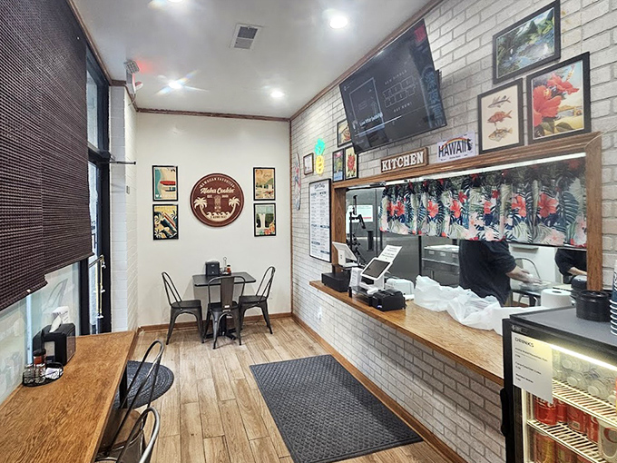 Inside, the cozy dining area features white brick walls, wooden accents, and just enough seating to create an intimate island atmosphere.