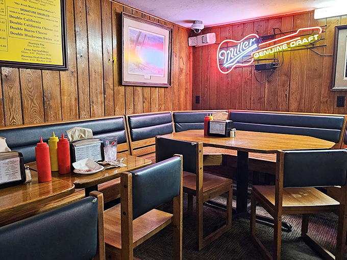 Wood-paneled walls and cozy booths create that perfect "neighborhood joint" vibe. The Miller sign glows like a beacon for thirsty burger enthusiasts.