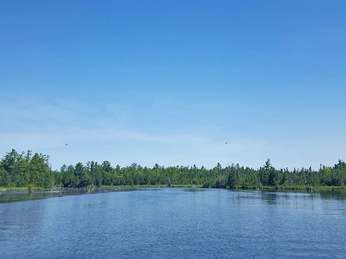 Serenity now! The glassy surface of Elk Lake invites contemplation and whispers promises of peaceful adventures.