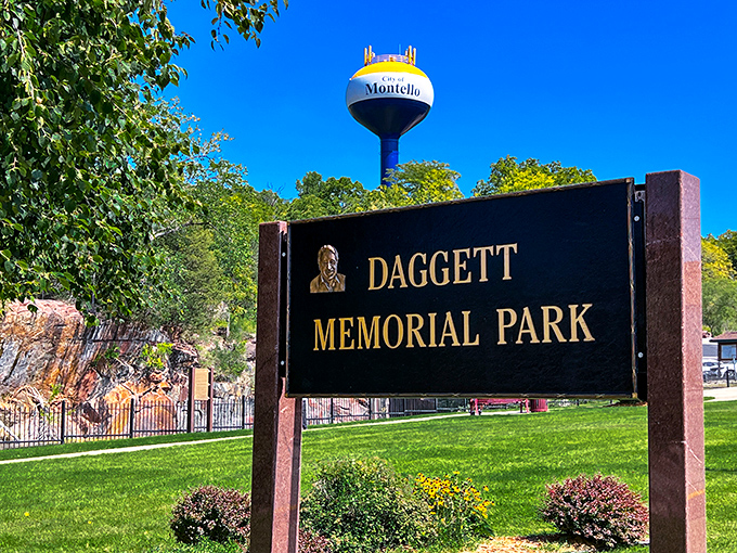 The welcoming sign to Daggett Memorial Park stands proudly against a blue sky, with the iconic Montello water tower keeping watch in the background.