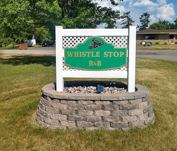 The Whistle Stop B&B sign stands proudly, a first whistle of welcome to weary travelers seeking unique accommodations.