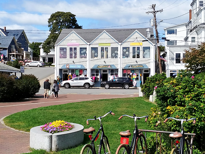 Colorful storefronts invite exploration along Boothbay's main street, where shopping becomes a treasure hunt for coastal keepsakes.