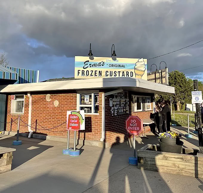 Even under moody skies, Erma's Original Frozen Custard shines as a beacon of sweetness with its iconic sign promising frozen perfection inside.